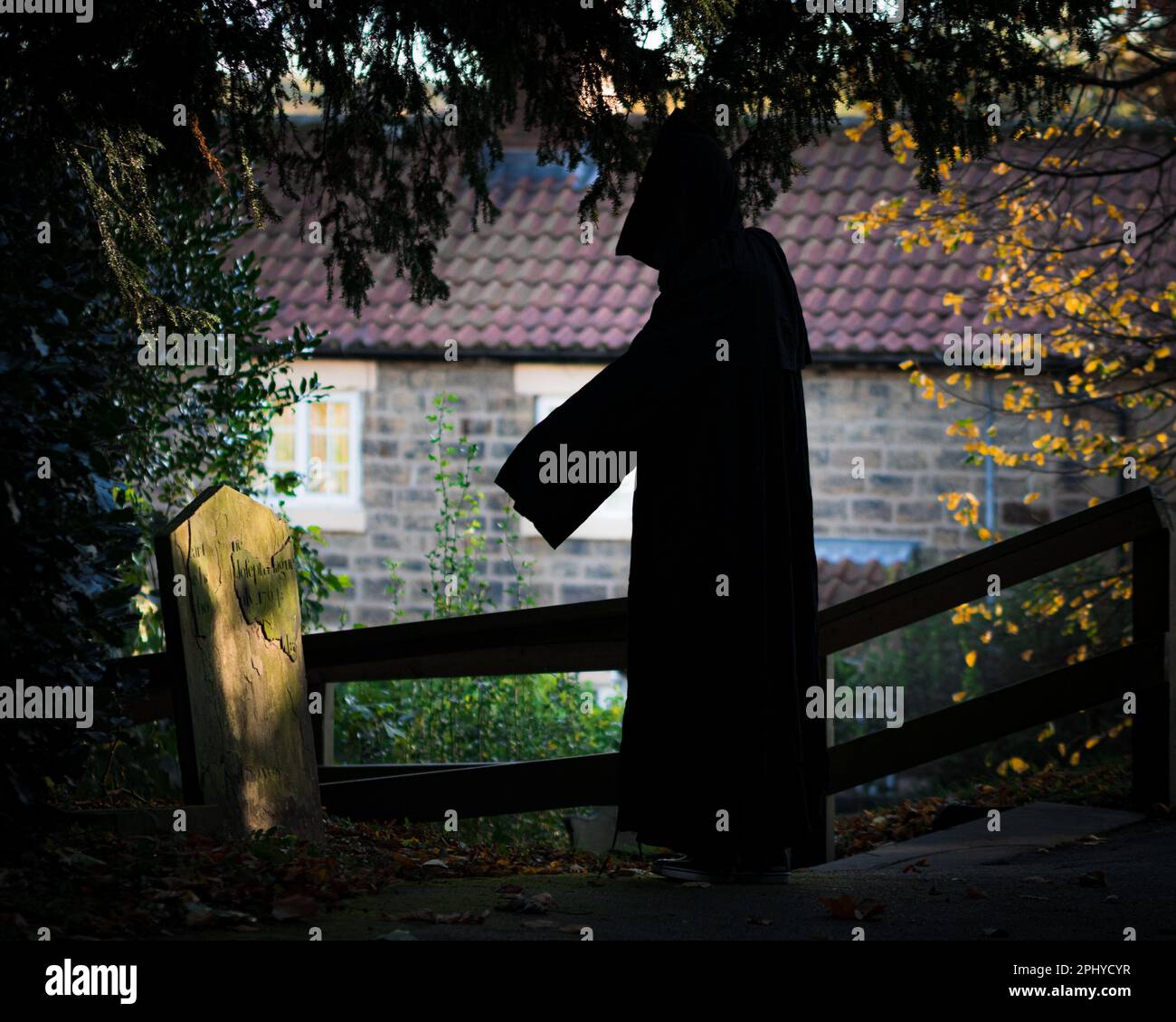 An image of a dark and foreboding figure, the Grim Reaper, standing ...