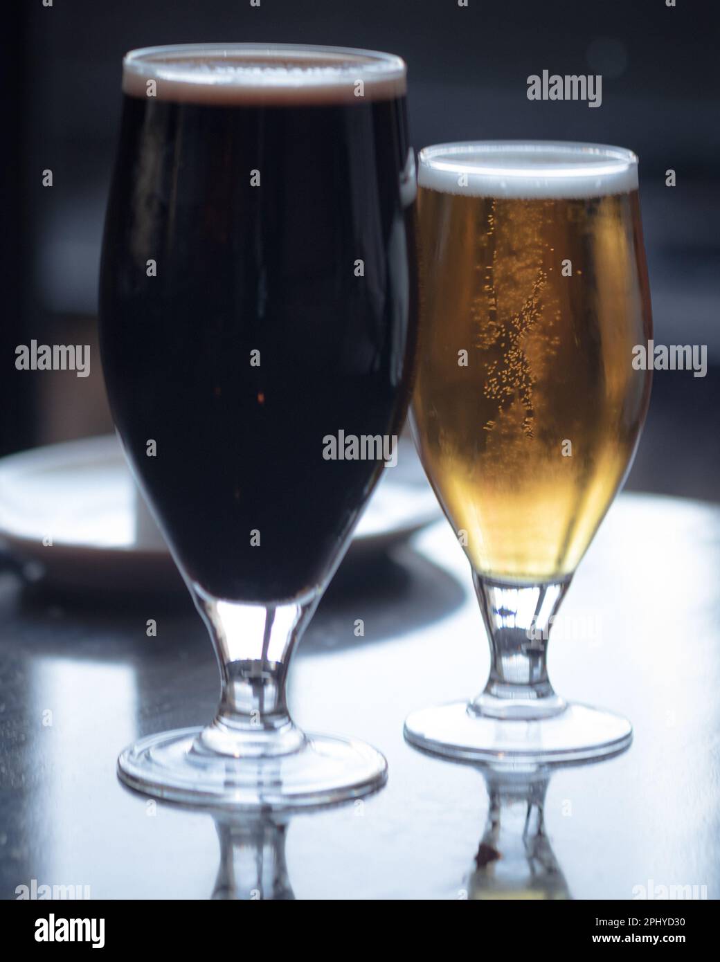 A stock photo of two different beers, arranged vertically in a side by ...