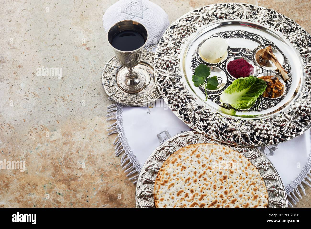 Composition with symbolic Passover, Pesach, items and meal on stone ...