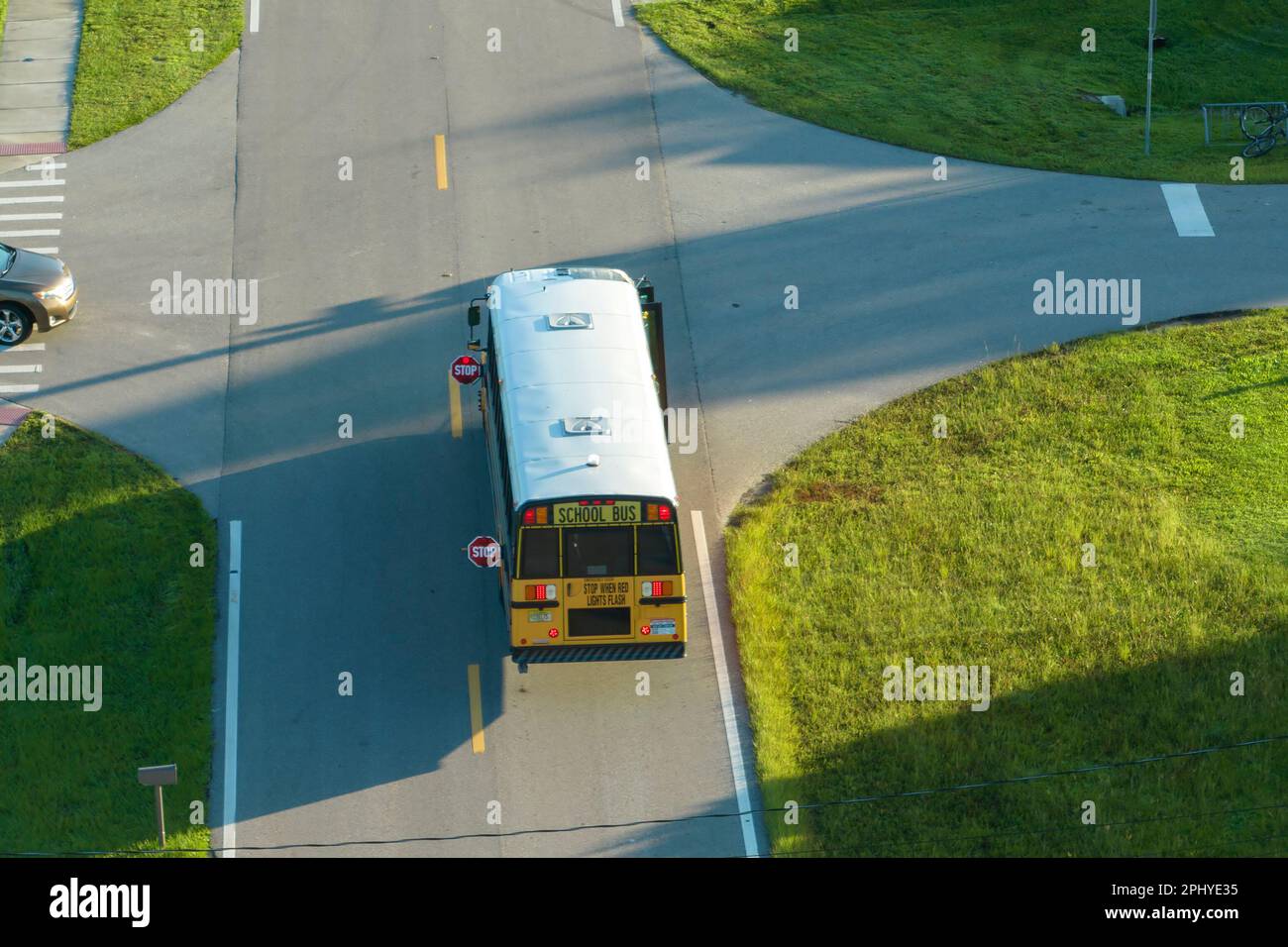 Top view of standard american yellow school bus picking up kids at ...