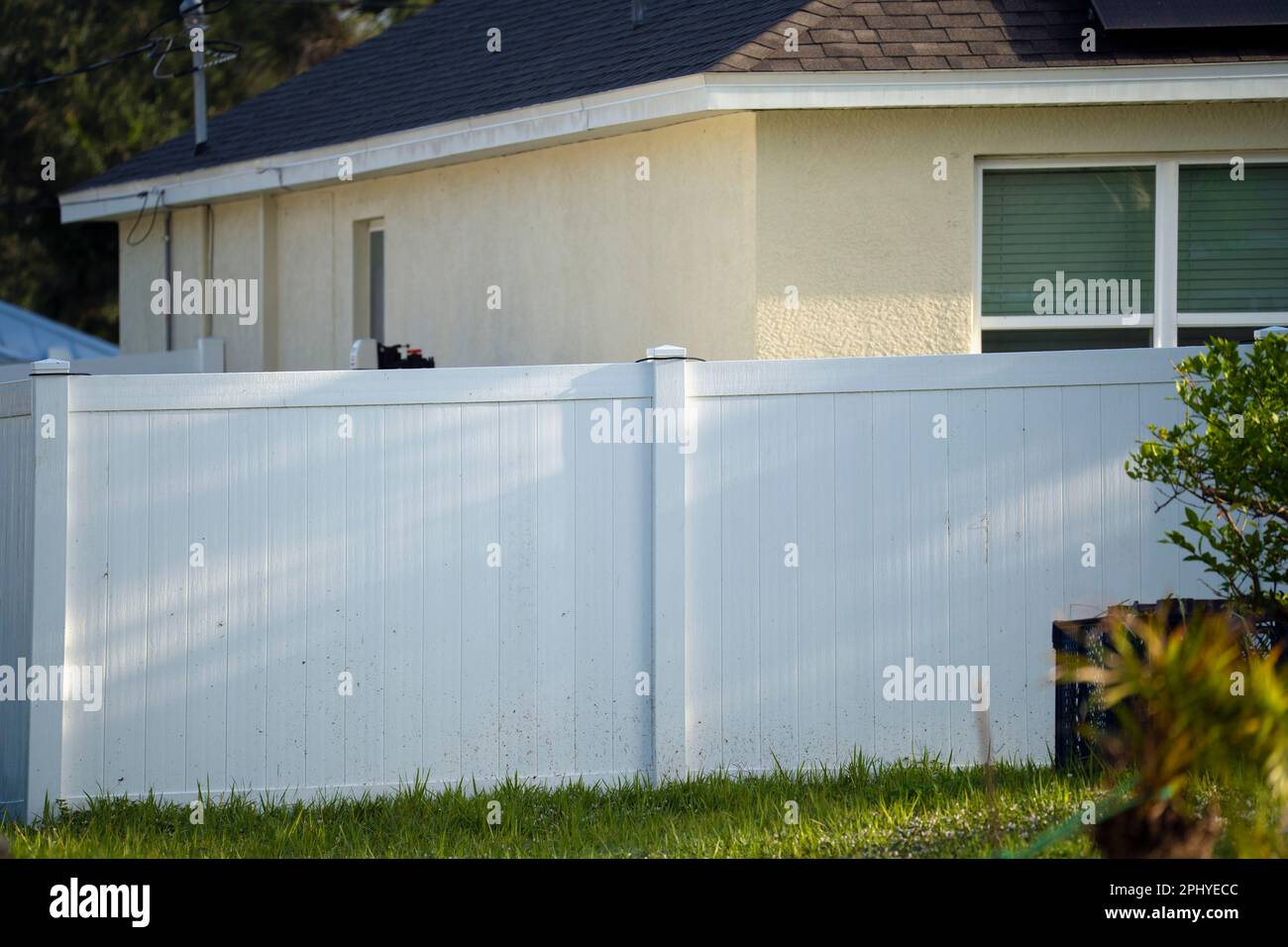 White plastic fence for back yard protection and privacy Stock Photo ...