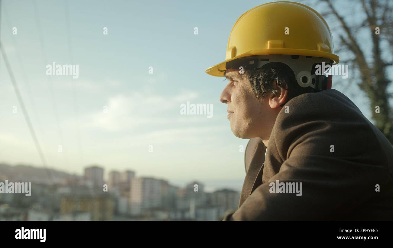 Young construction engineer or contractor, wearing a hard hat and suit ...