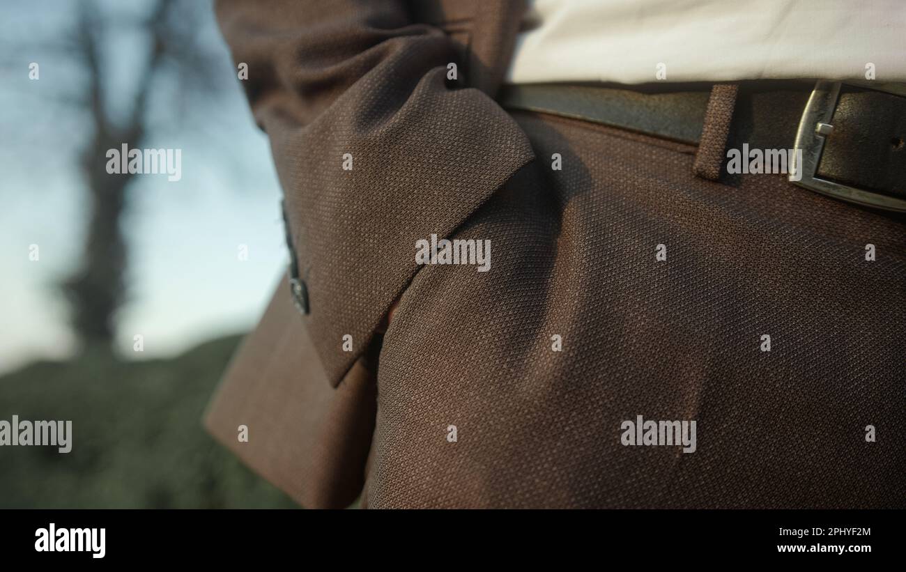 Man in suit puts hand in pocket in extreme close-up shot Stock Photo ...
