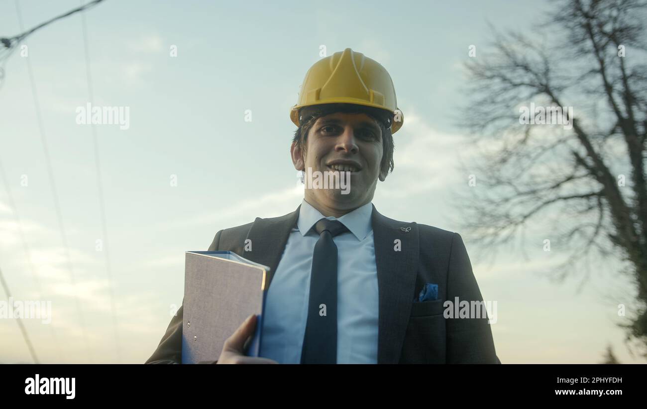 Successful Businessman or Contractor Holding Blue Folder, Takes off ...