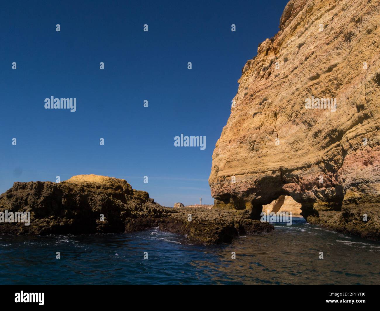 One of the golden sandstone caves along the Algarve Atlantic Ocean ...