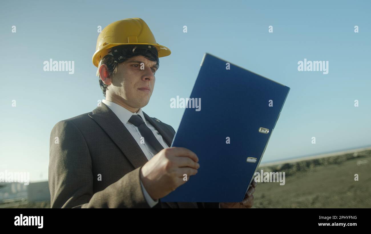 Focused Businessman or Engineer Holding Blue Folder in Workplace Stock ...