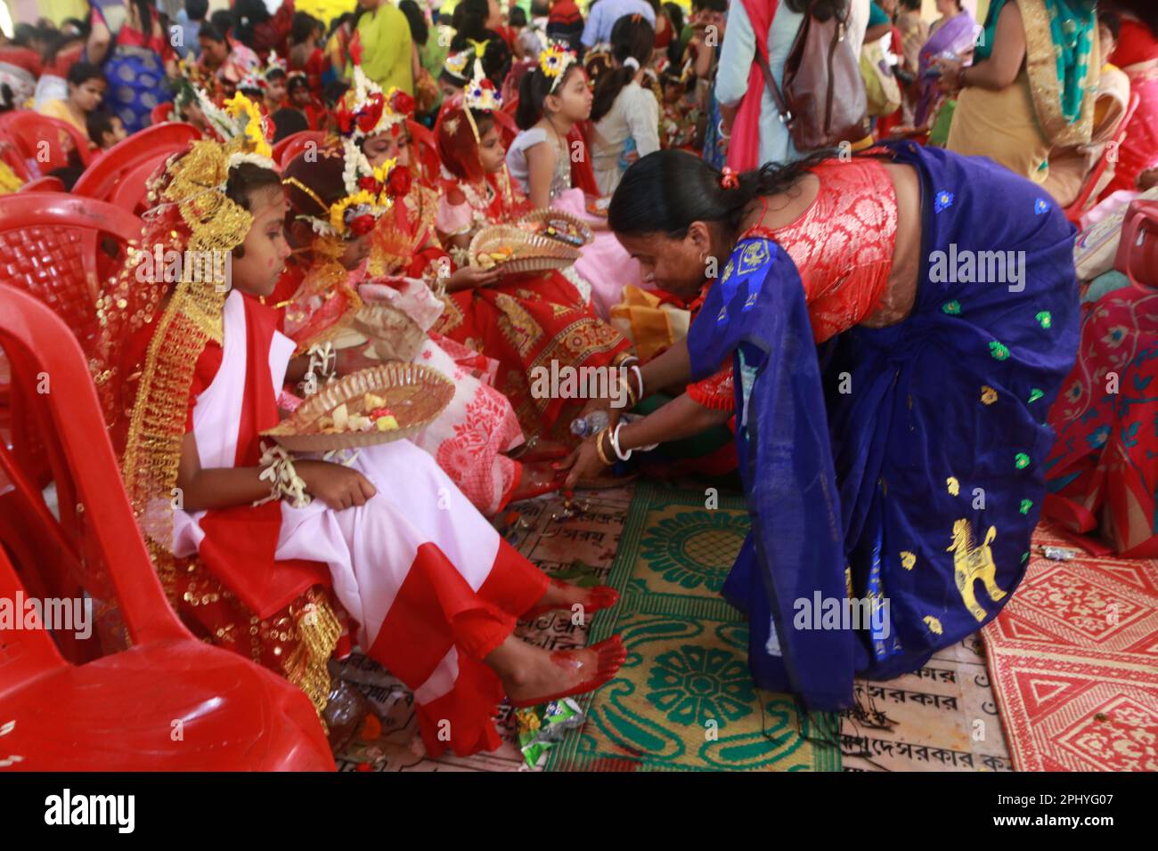 Kolkata, India. 30th Mar, 2023. Hindu girls sit together for a ceremony ...