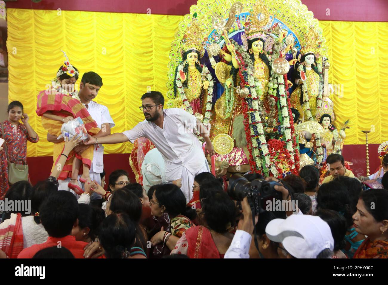 Kolkata, India. 30th Mar, 2023. Hindu girls sit together for a ceremony ...