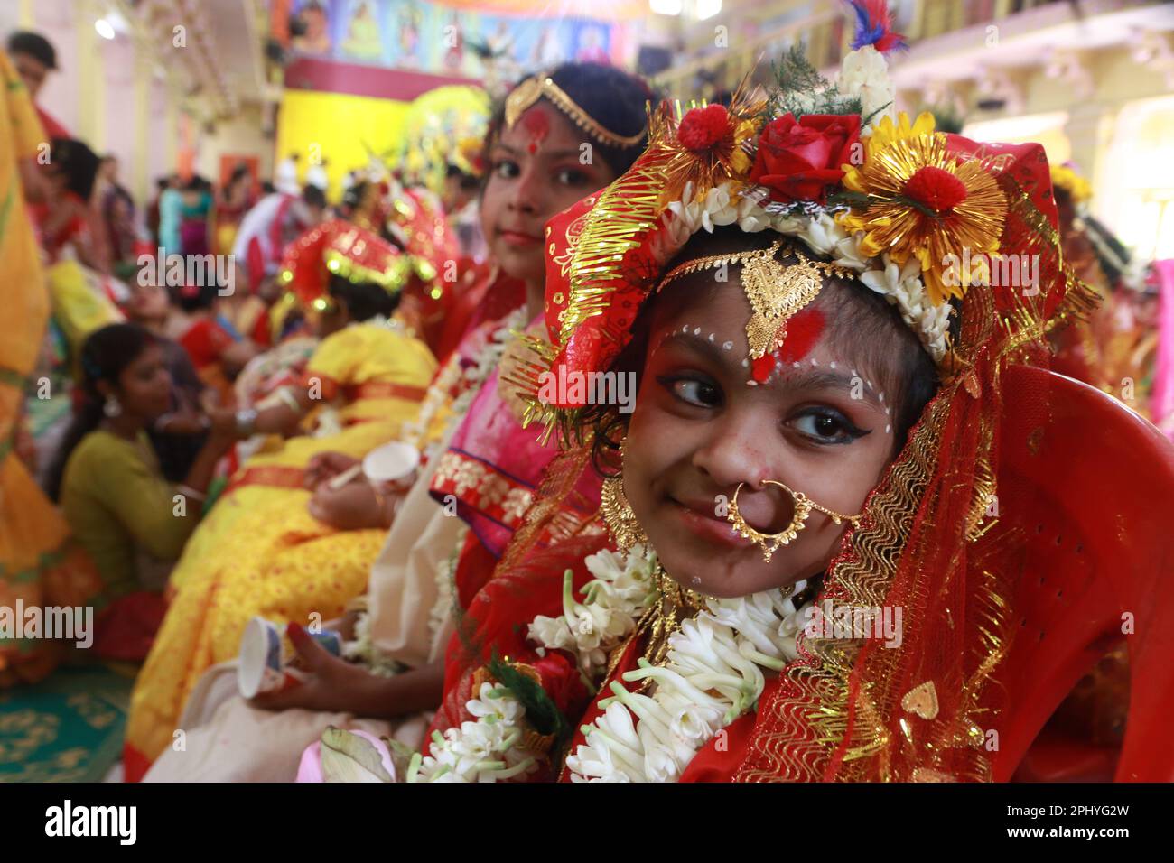 Kolkata, India. 30th Mar, 2023. Hindu girls sit together for a ceremony ...