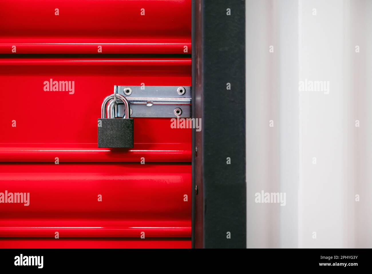 Padlock of self storage door with red door Stock Photo - Alamy