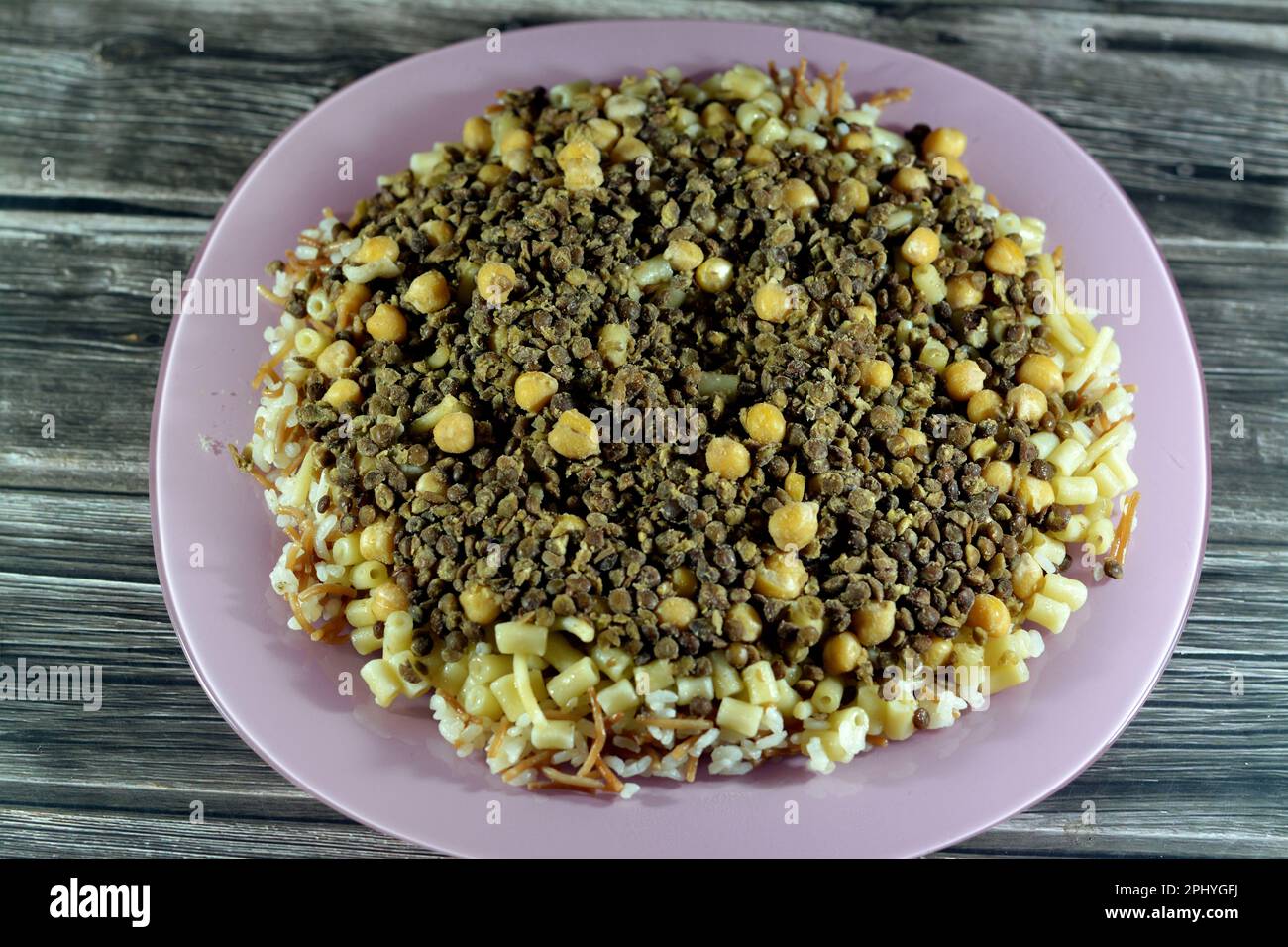 Egyptian cuisine of Koshary, a popular street food made of rice ...