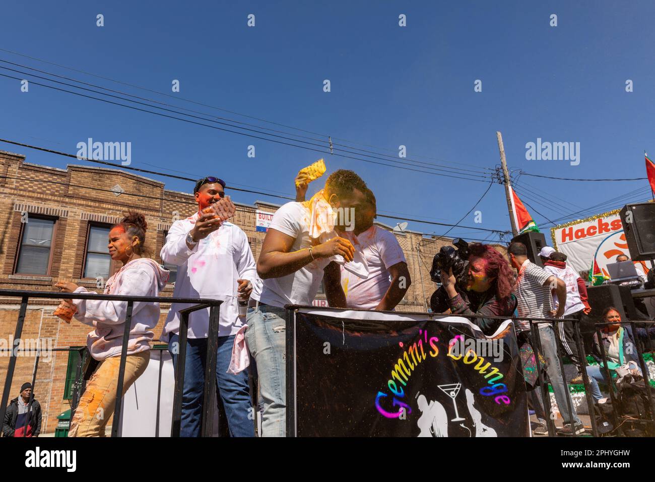 A group of diverse people spreading color powder on each other at the ...