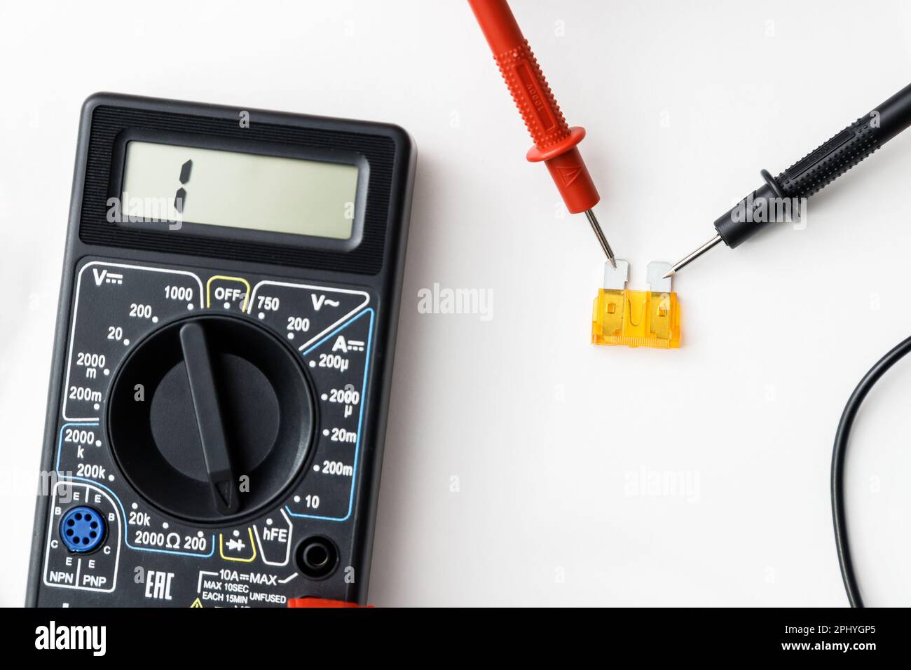Checking faulty colored automotive fuse with digital multimeter on ...