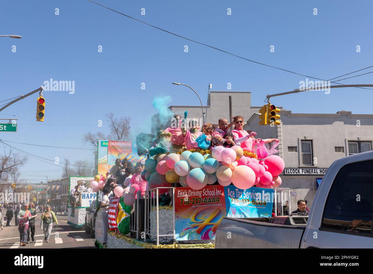 A group of diverse people spreading color powder on each other at the ...