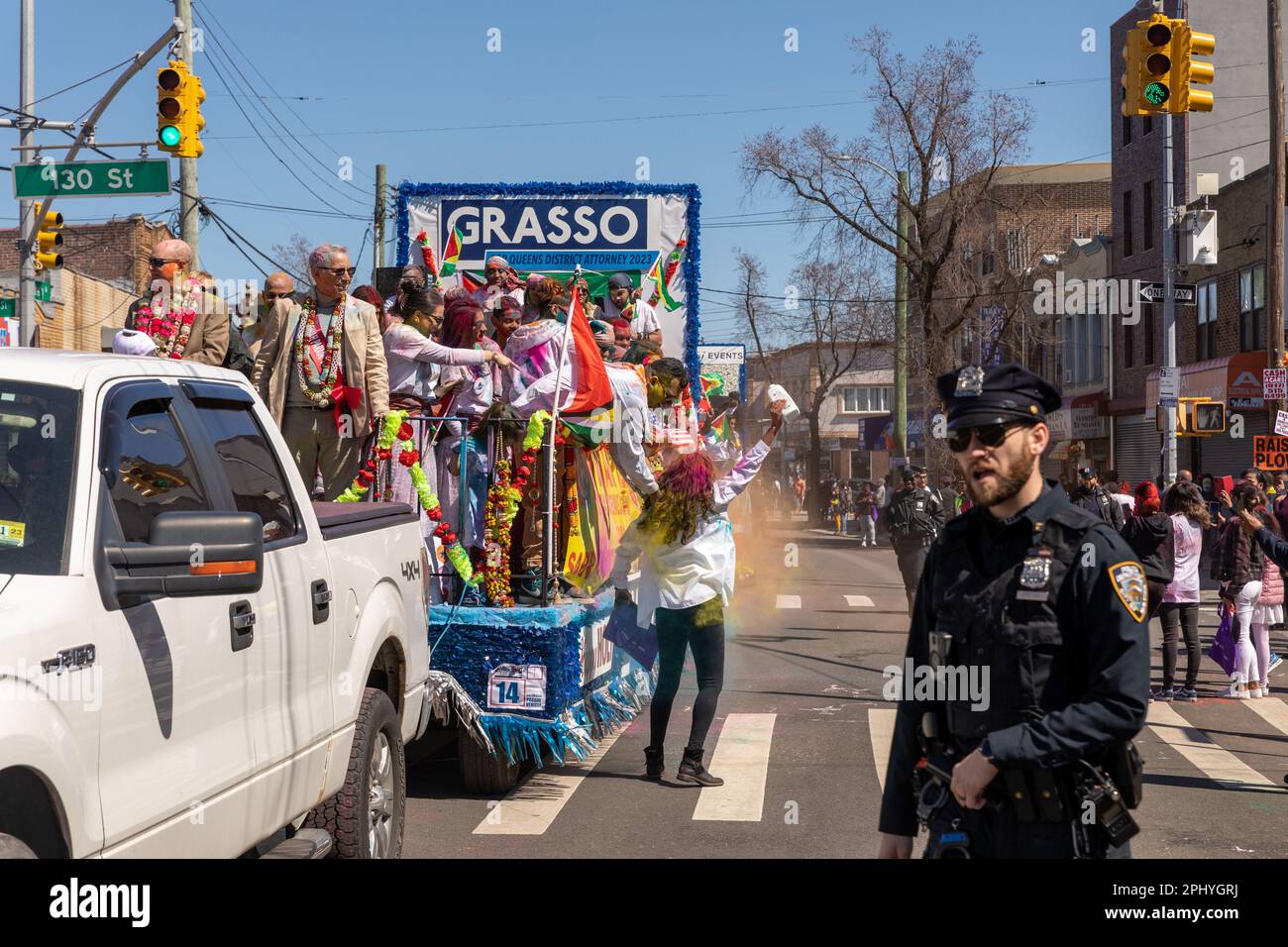A group of diverse people spreading color powder on each other at the ...