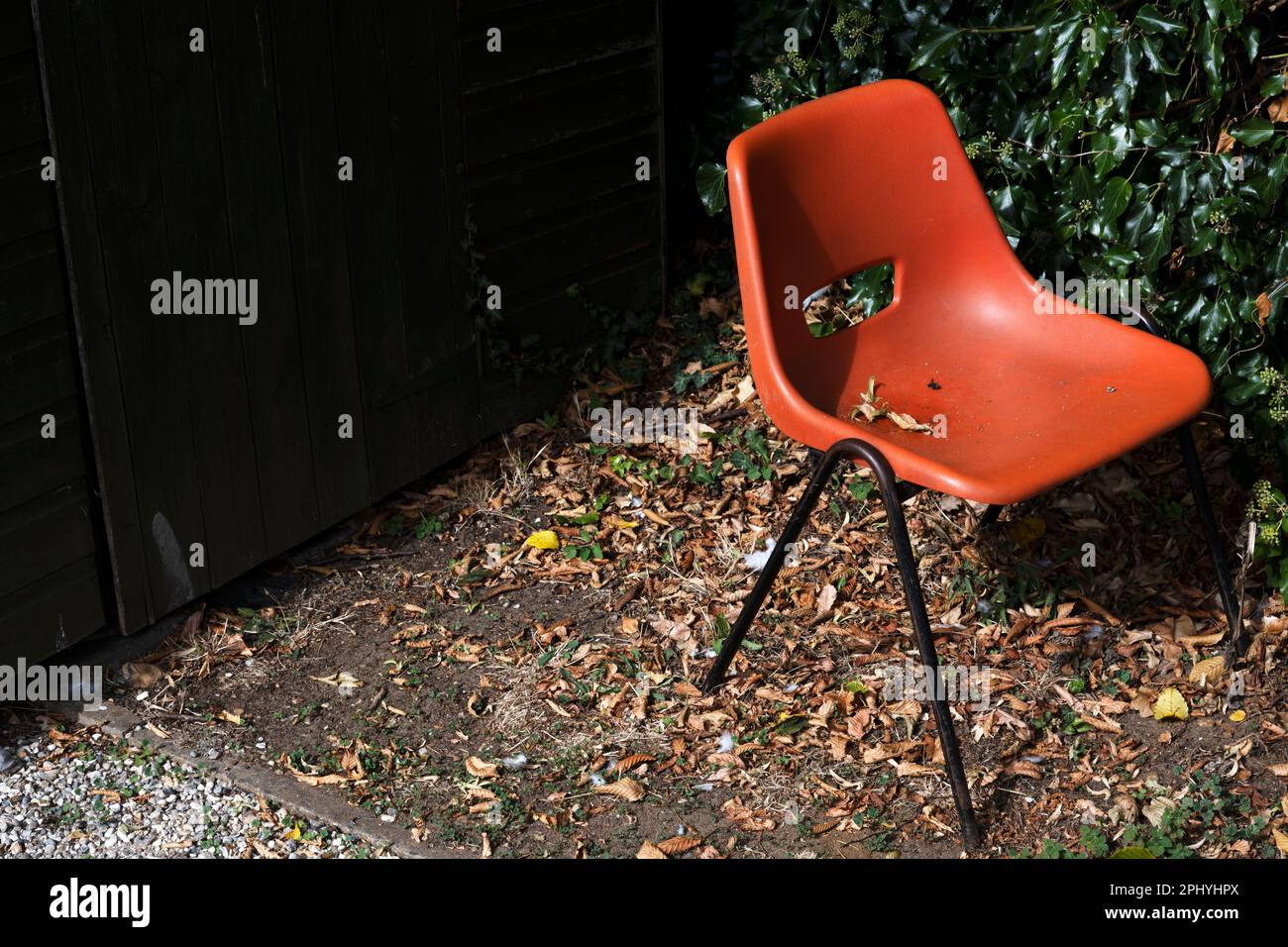 Plastic chair left outside Stock Photo - Alamy