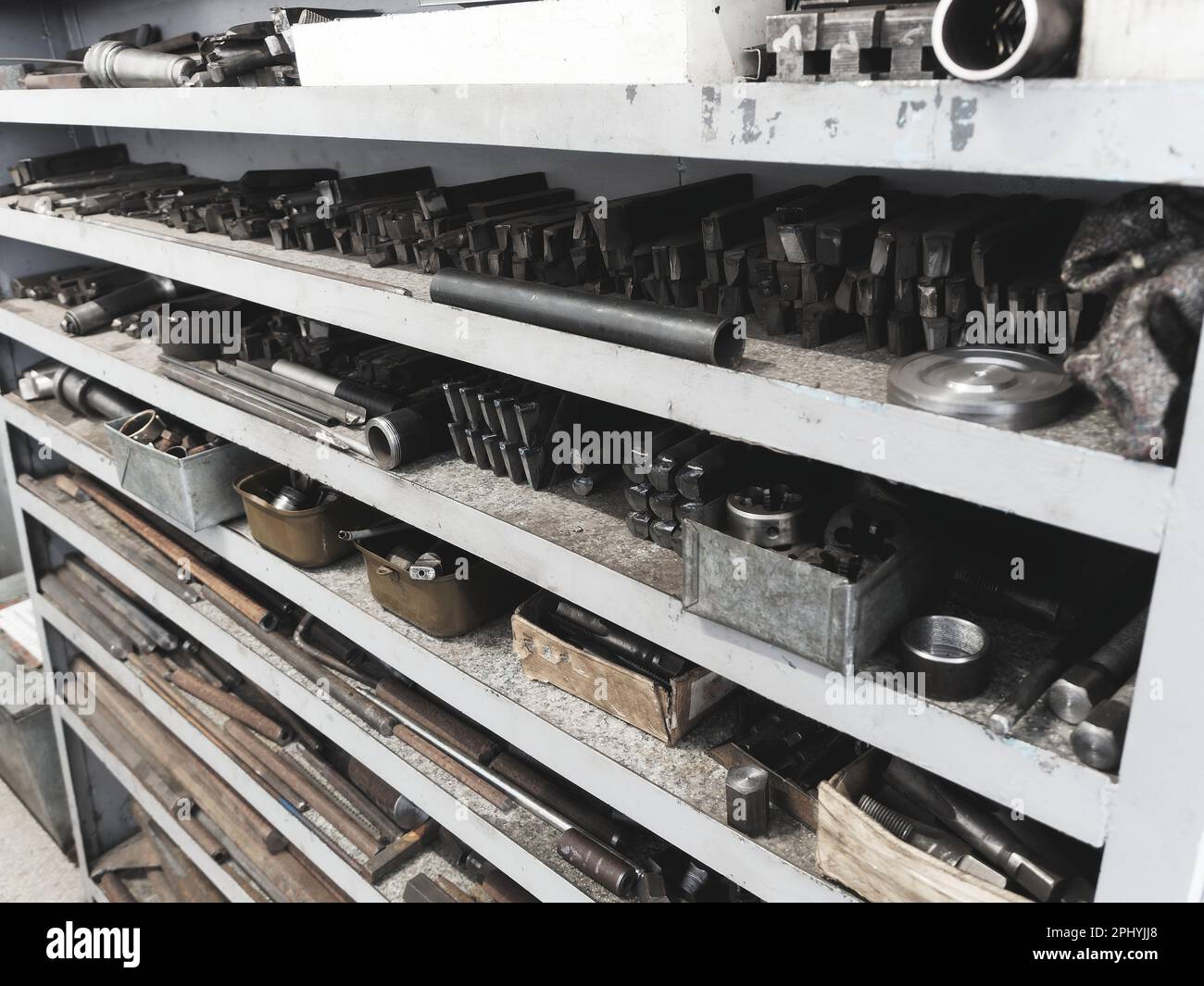 Metal rack with drills blanks in lathe shop. Industrial background ...