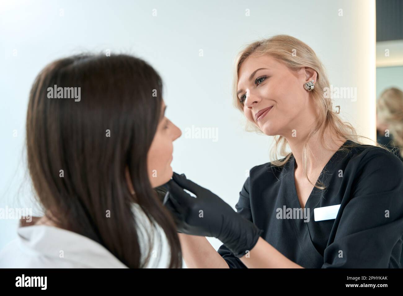 Dermatologist examining lady face before skin treatment Stock Photo - Alamy
