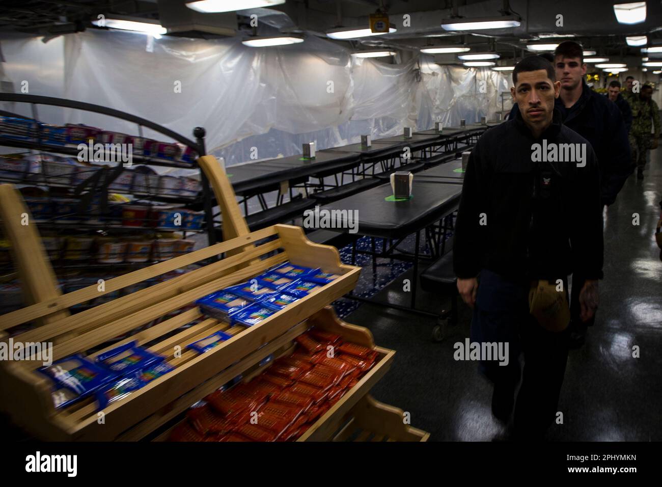 Sailors of the USS Bataan make their way through one of the ship's four ...