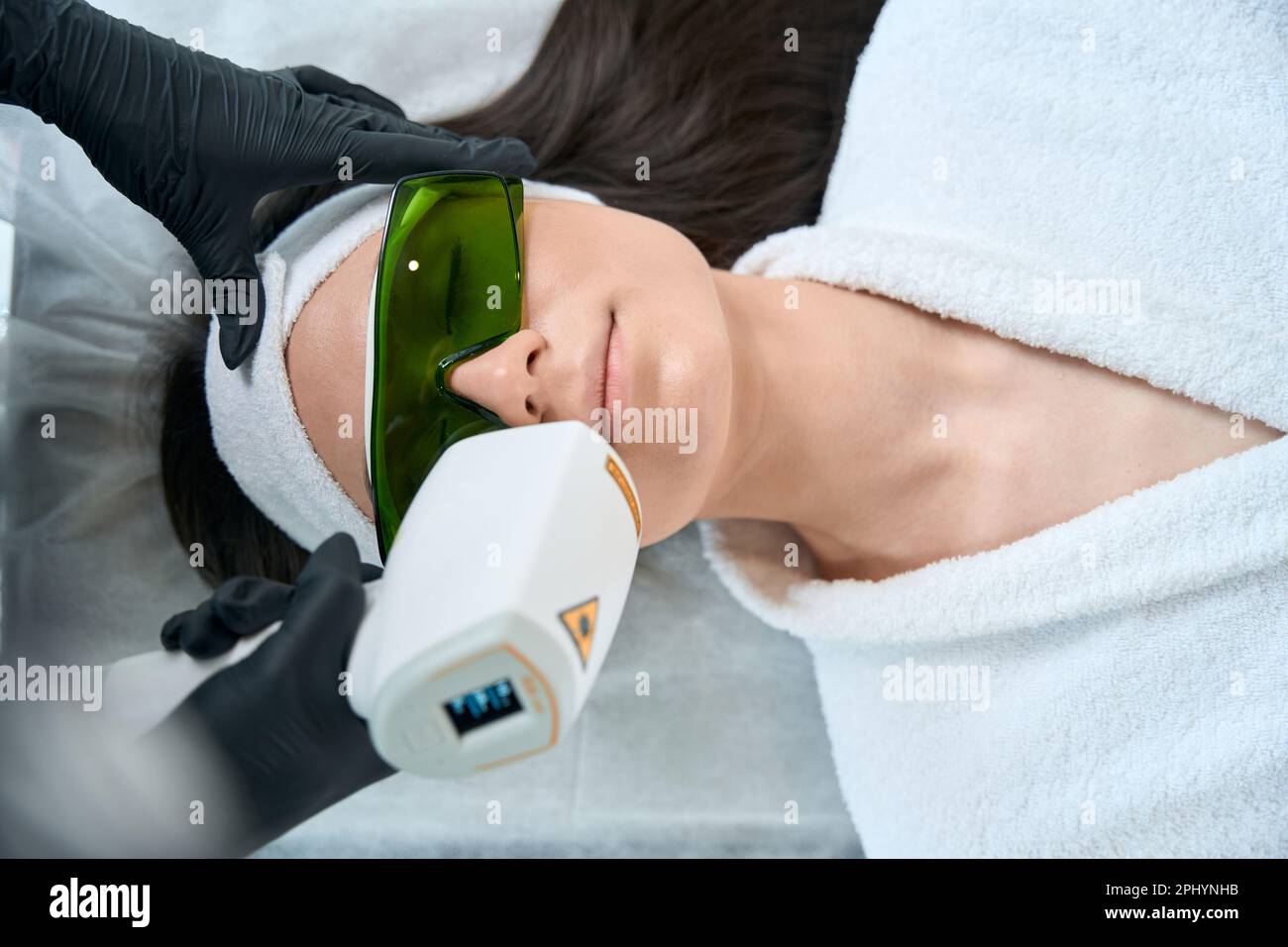 Close up photo of female doing face laser hair removal Stock Photo - Alamy
