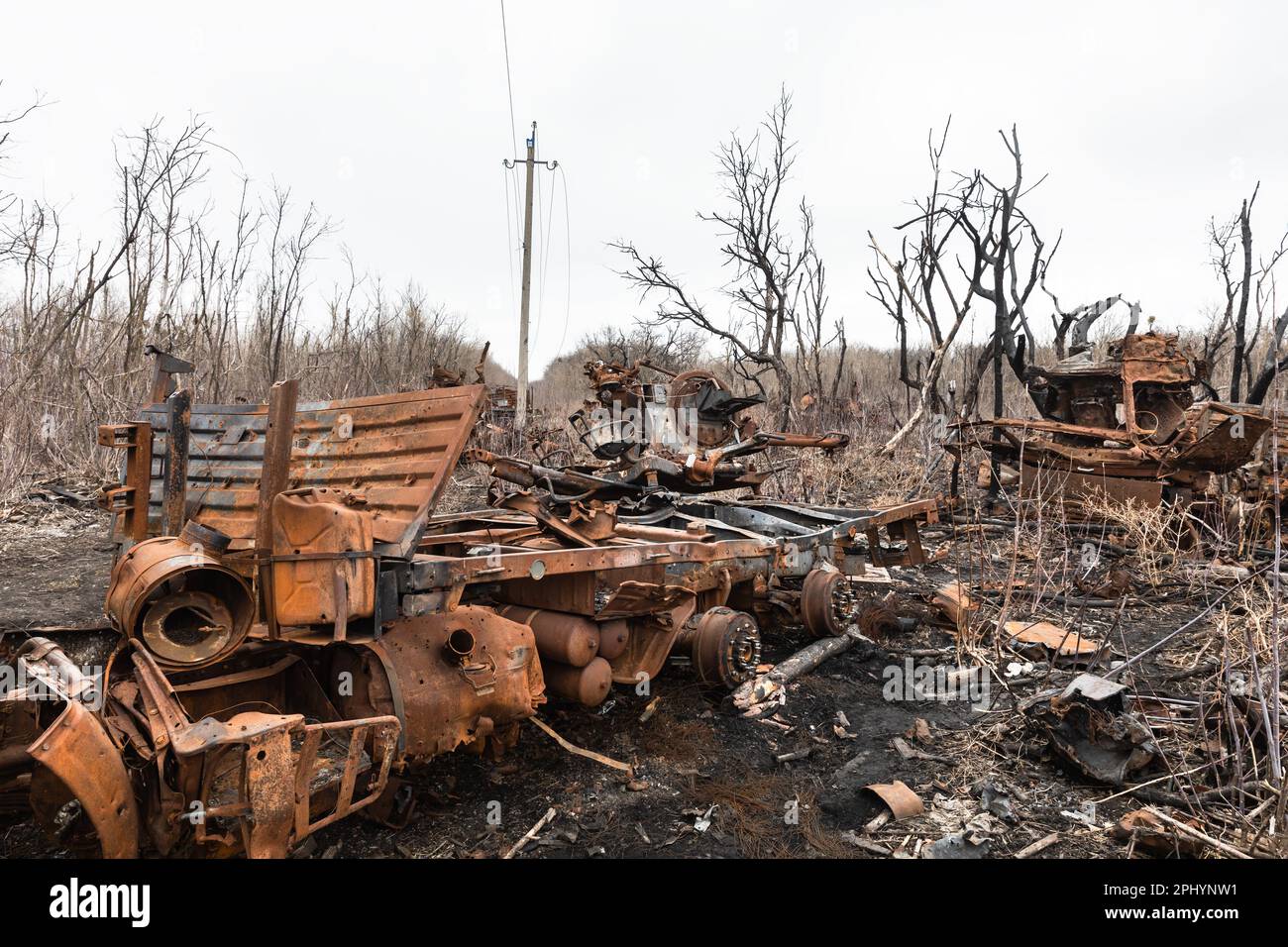Burnt-out military equipment and mangled burnt trees can be seen at the ...