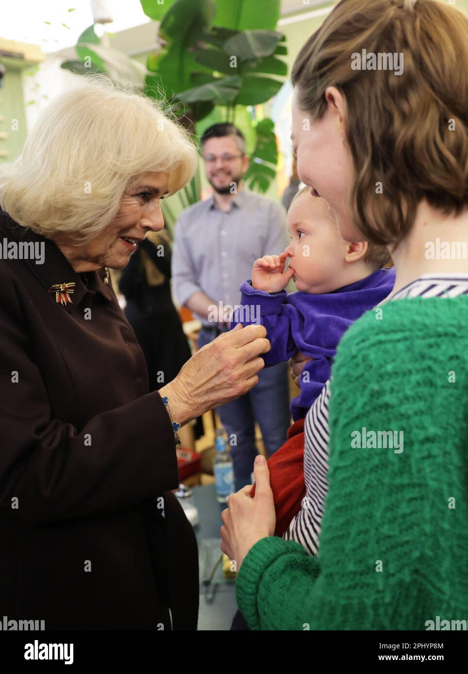 The Queen Consort speaks with Diana Strassheim and baby Kuno during a ...
