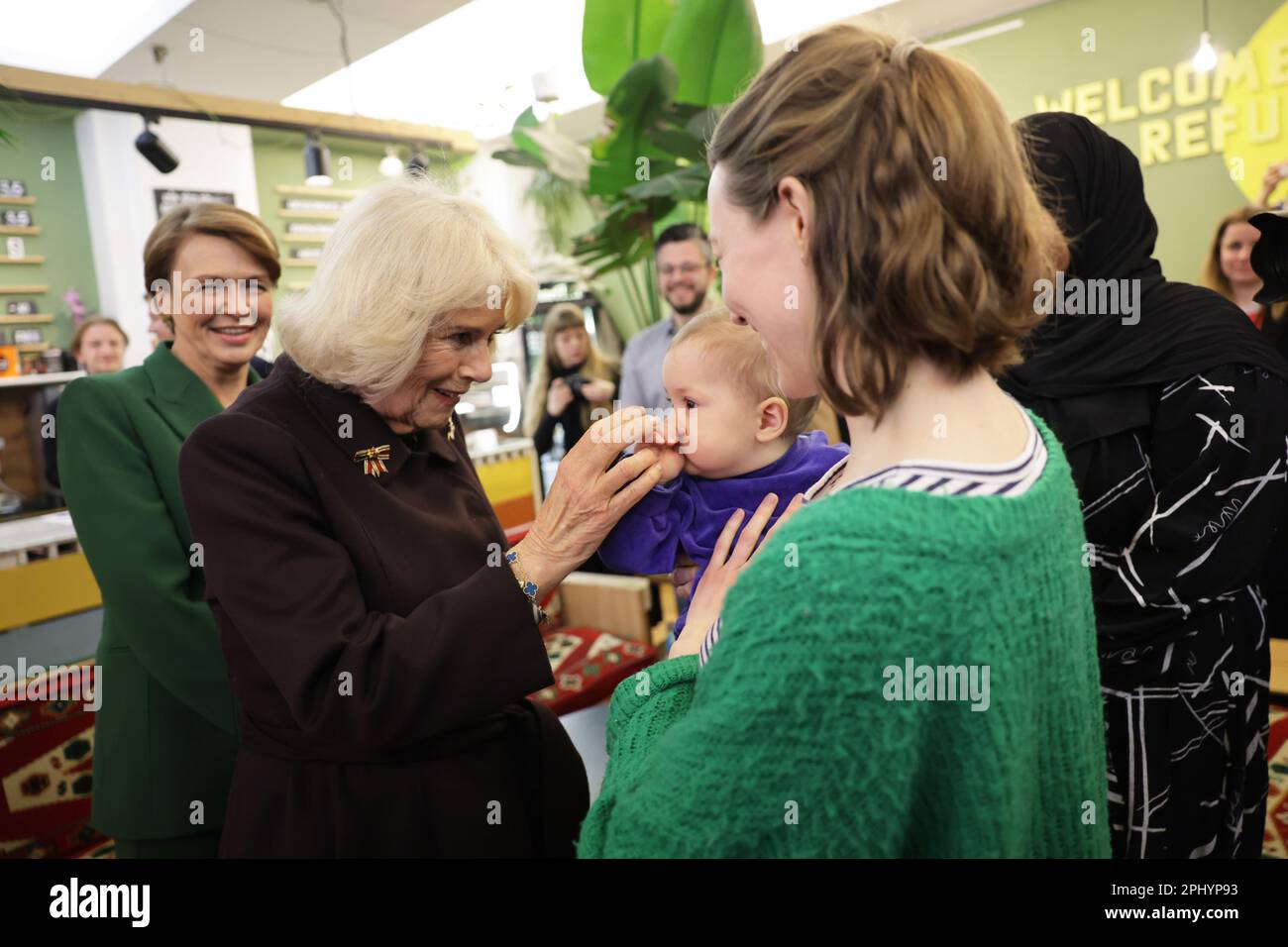 The Queen Consort speaks with Diana Strassheim and baby Kuno during a ...