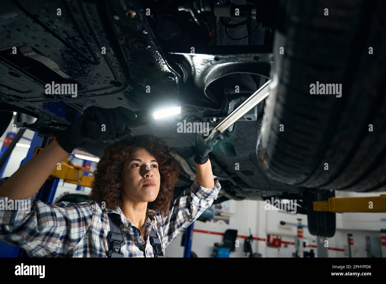 Car on a special lift is undergoing maintenance Stock Photo - Alamy