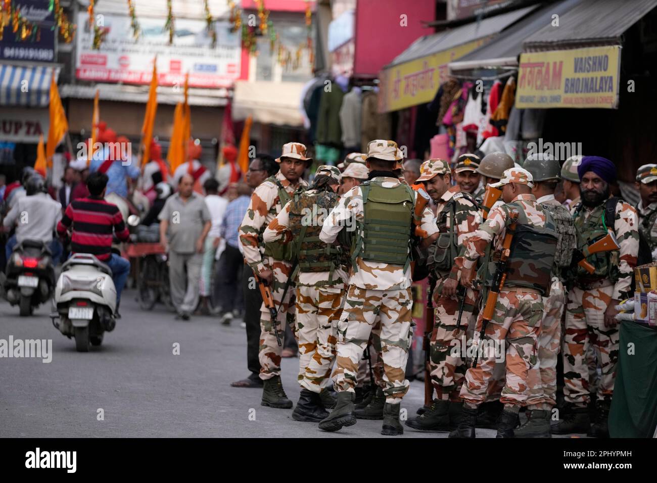 Indian paramilitary soldiers stand guard during a procession marking ...