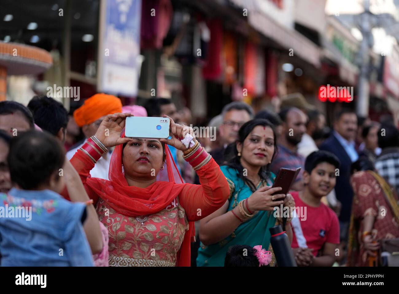 People watch a procession marking the Hindu festival of Ram Navami, in ...