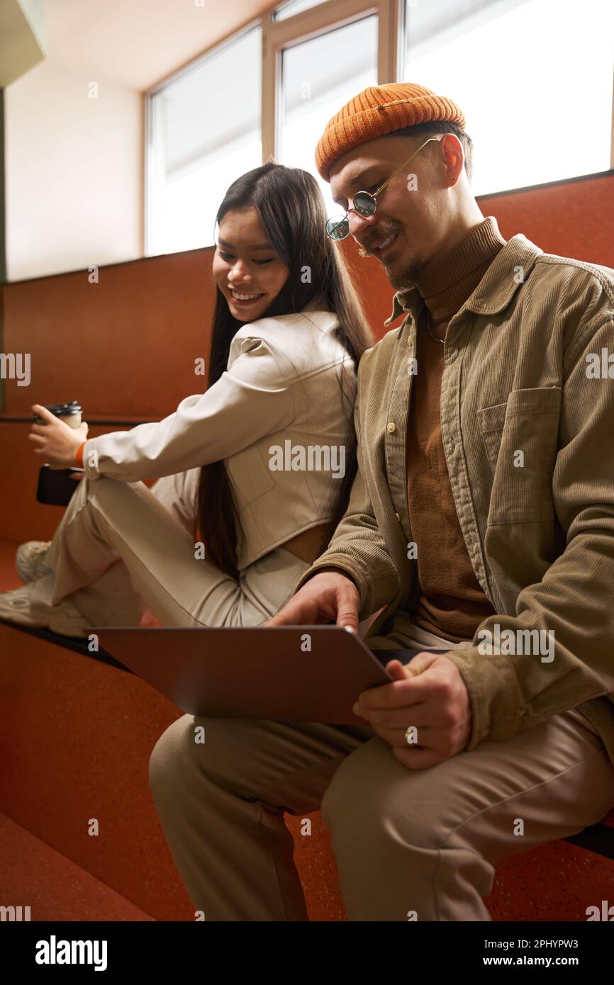 Joyous woman and man watching video on computer monitor Stock Photo - Alamy