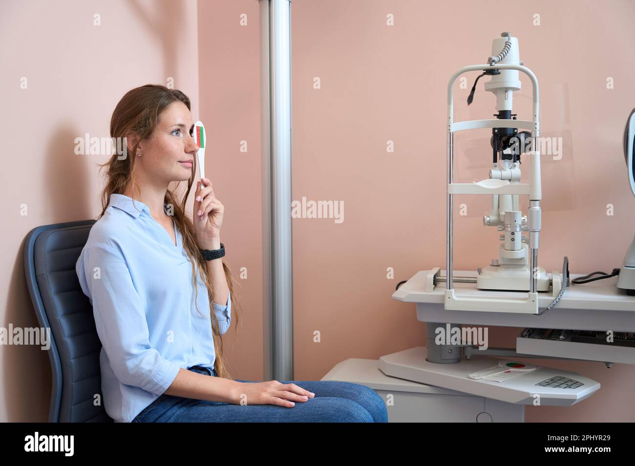 Beautiful Caucasian female is covering one eye in the ophthalmology office Stock Photo - Alamy