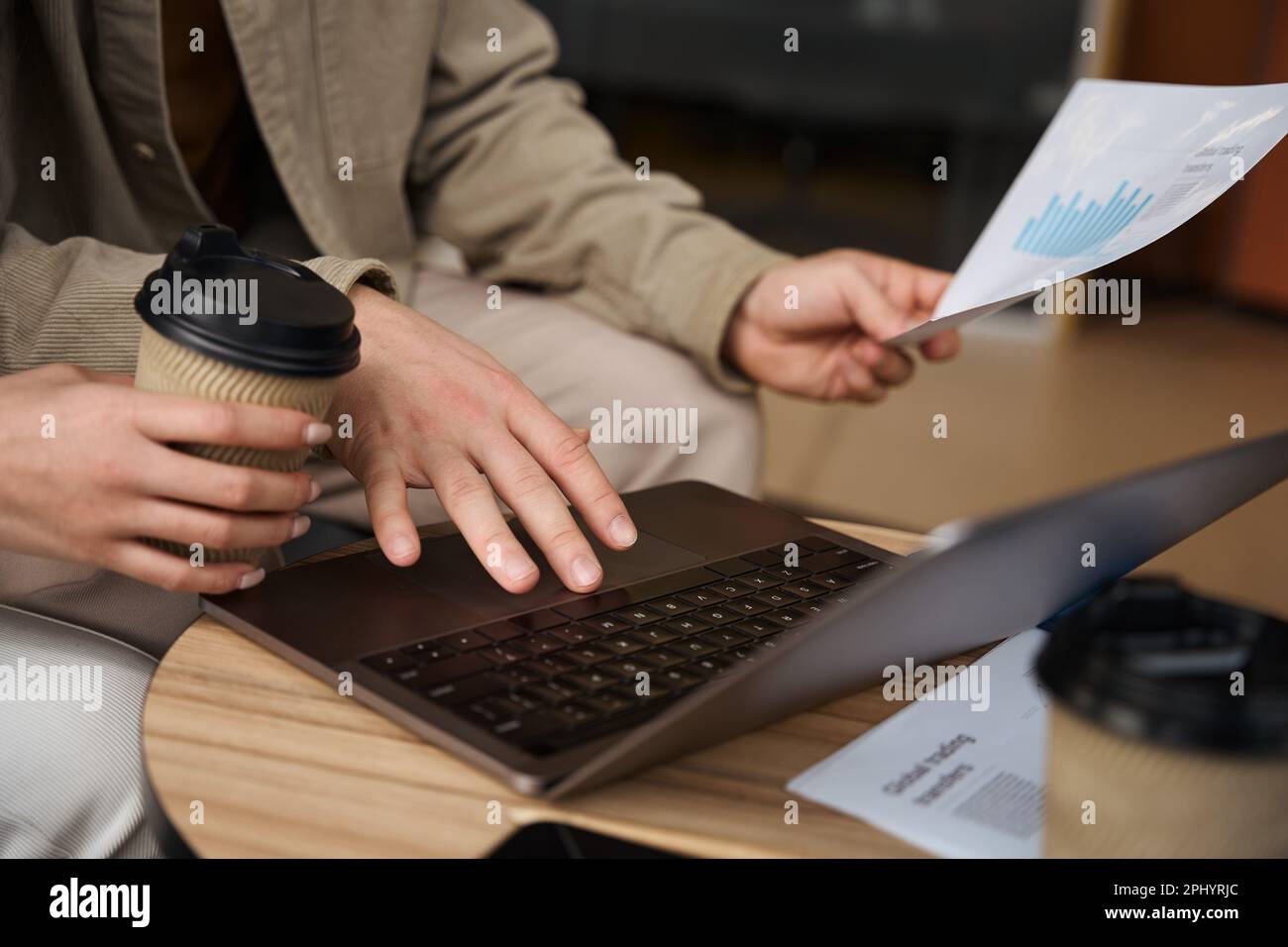 Company employees using laptop at office desk Stock Photo - Alamy
