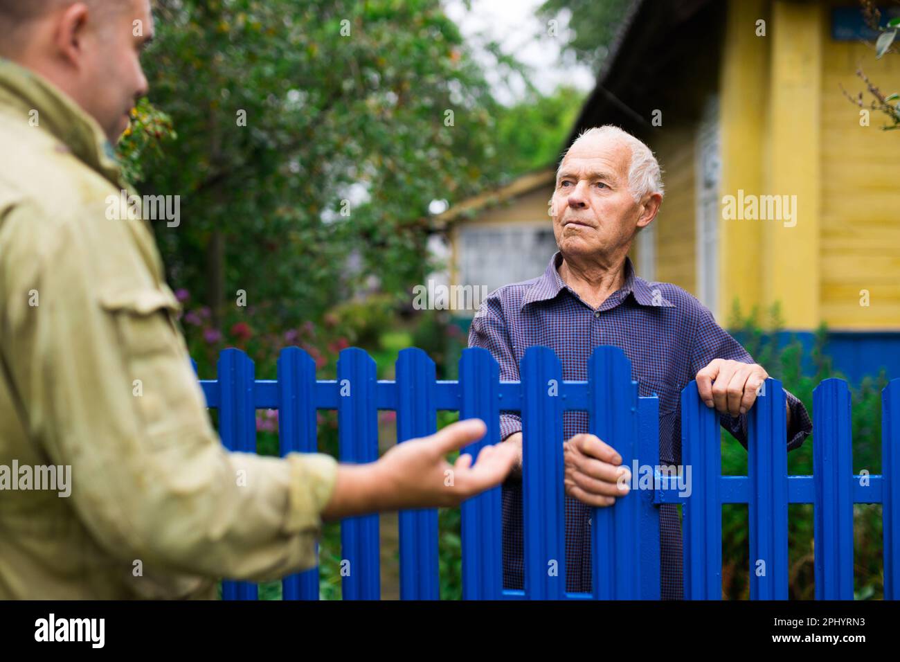 Old man talking with his neighbour Stock Photo - Alamy