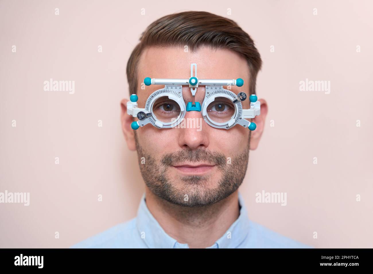 Confident male doing check up his visual acuity with special equipments ...