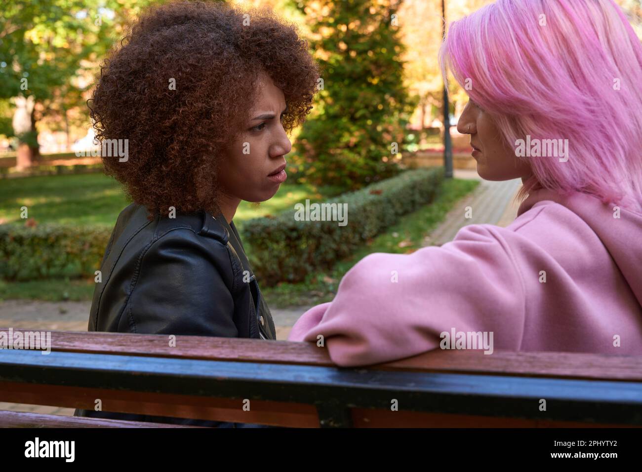 Angry woman having serious conversation with friend outdoors Stock ...