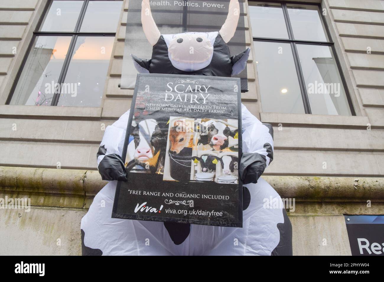 London, UK. 29th Mar, 2023. A protester wearing a cow costume holds an ...