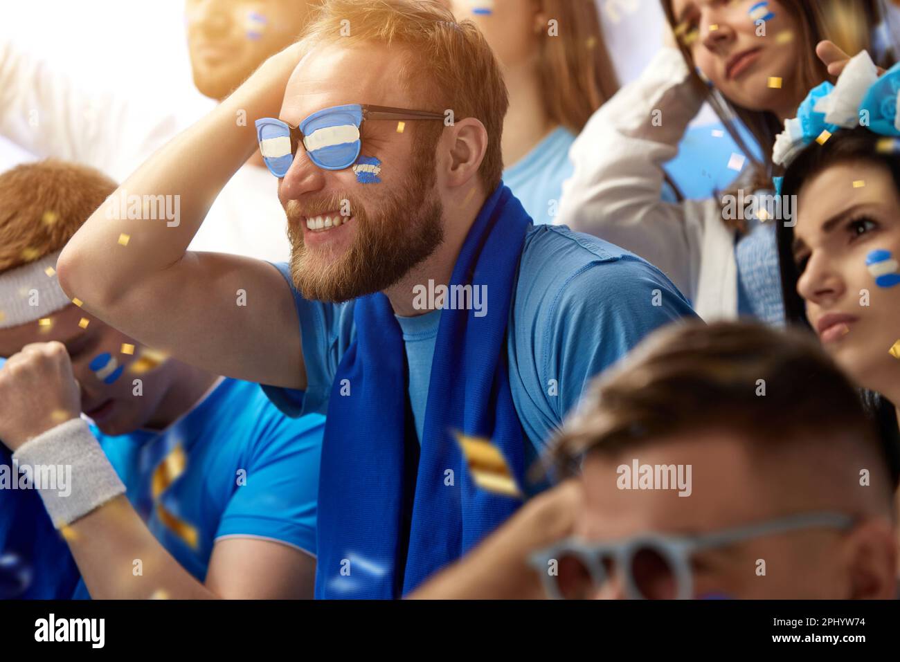 Losing goal. Emotional young people watching football match, supporting ...