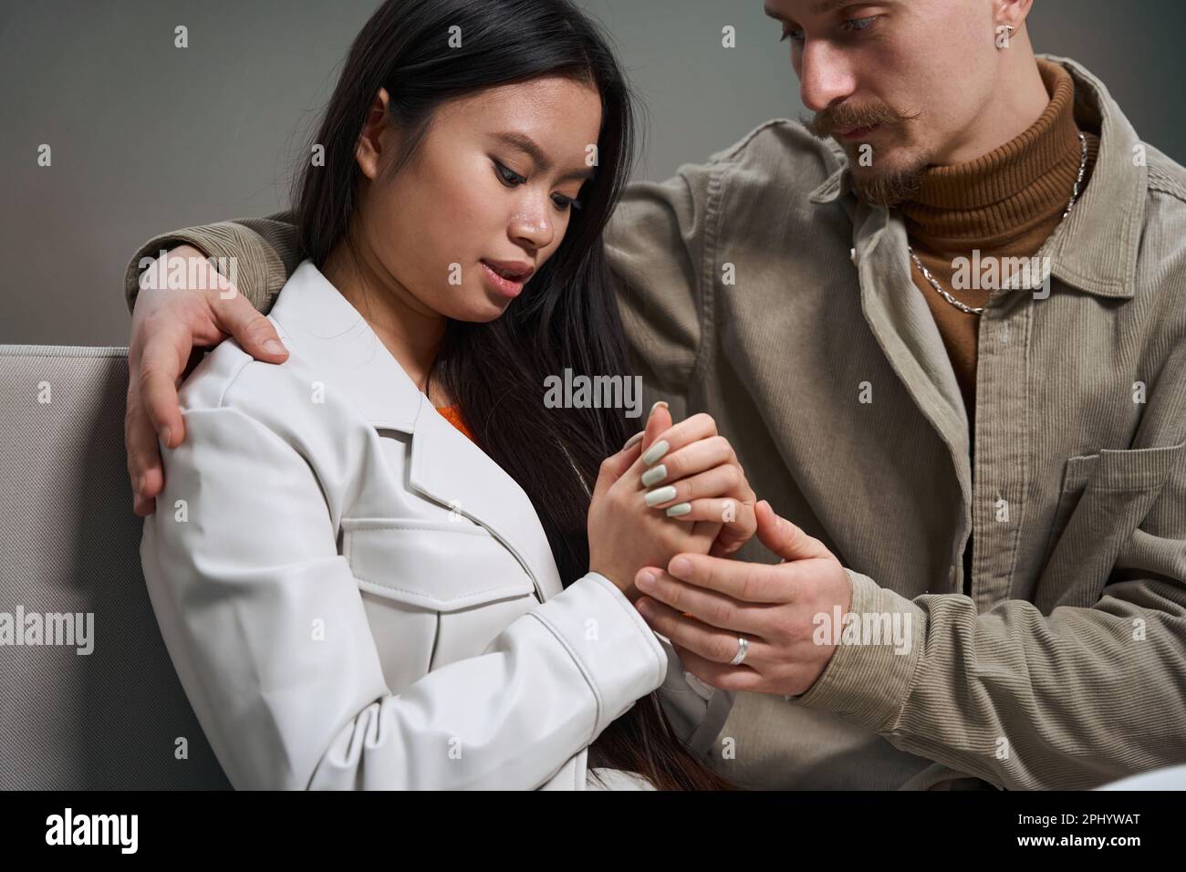 Caring Caucasian guy comforting his despondent girlfriend Stock Photo ...