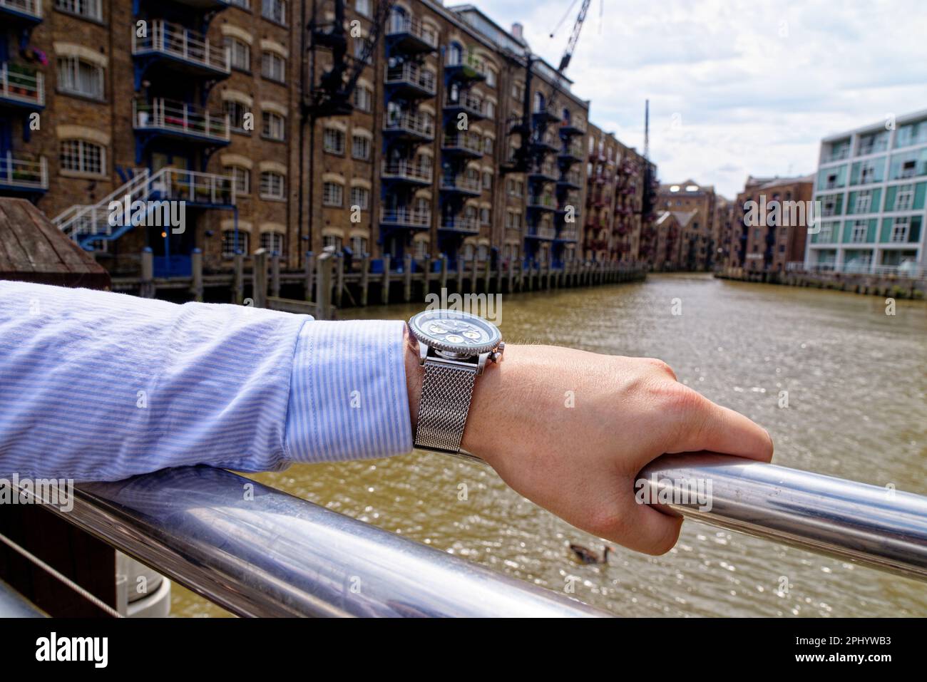 Young man in China Wharf London wearing fashion watch - London, United ...