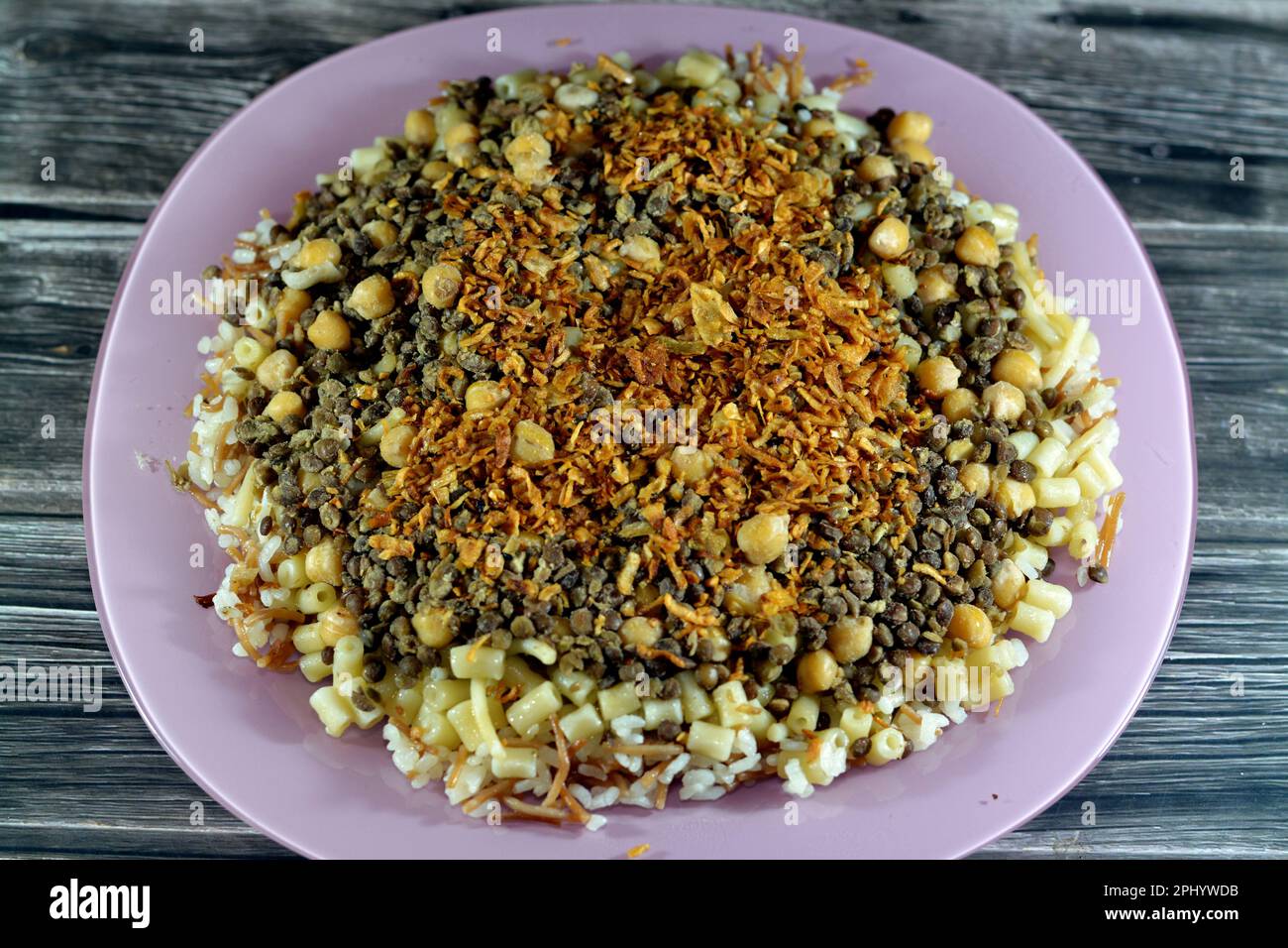 Egyptian cuisine of Koshary, a popular street food made of rice ...