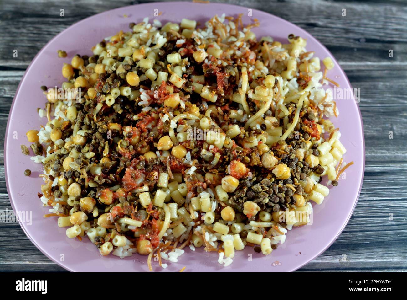 Egyptian cuisine of Koshary, a popular street food made of rice ...