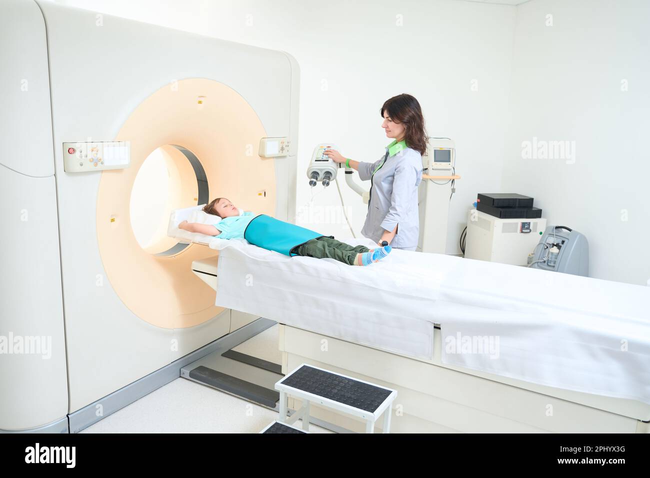 Female doctor conducting a CT scan of the brain of child Stock Photo ...