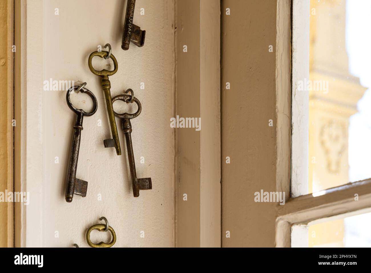 A collection of old steel keys for historical locks. The keys hang on a ...