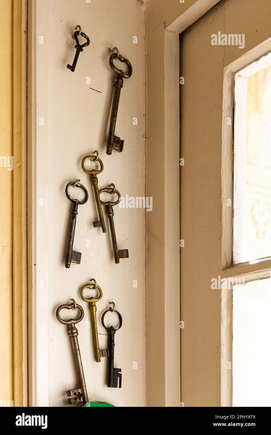 A collection of old steel keys for historical locks. The keys hang on a ...