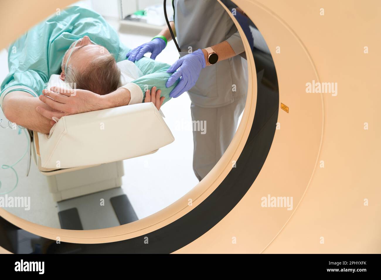 Adult man lying and holding hands up in chamber of MRI machine Stock ...