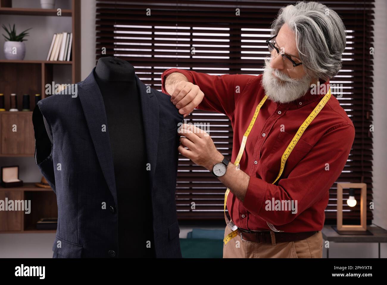 Professional tailor working with mannequin in atelier Stock Photo - Alamy