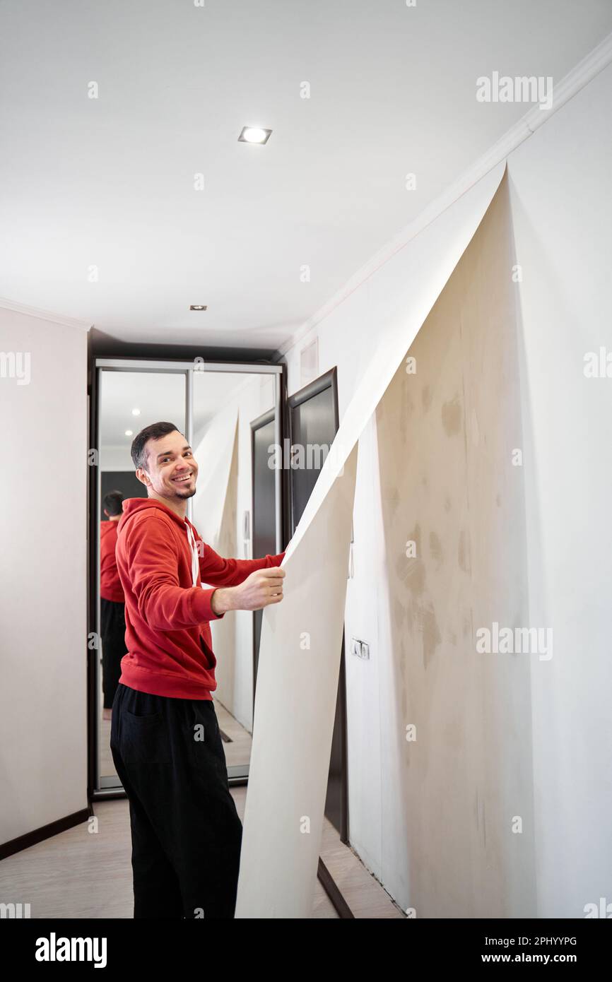 Repair the house with their own hands. The guy is ripping the old ...