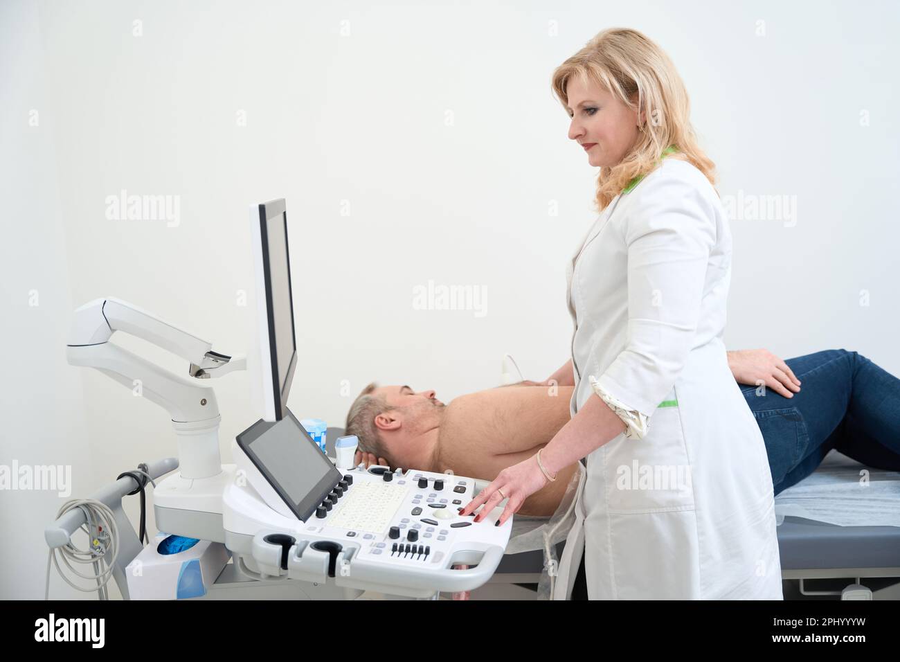 Doctor examining heart of patient by echocardiogram for diagnosis ...