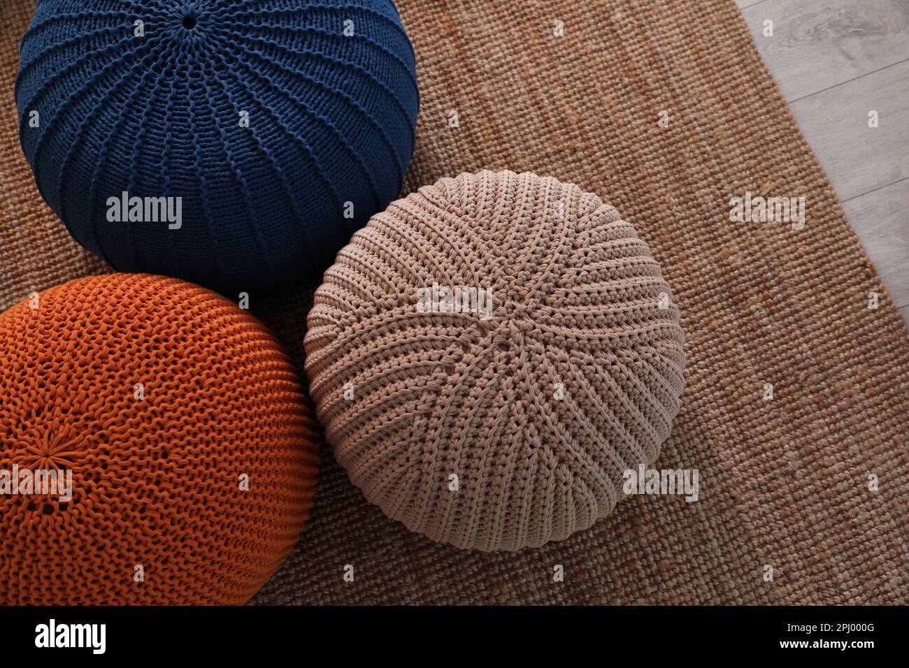 Stylish comfortable poufs on carpet, top view. Home design Stock Photo ...